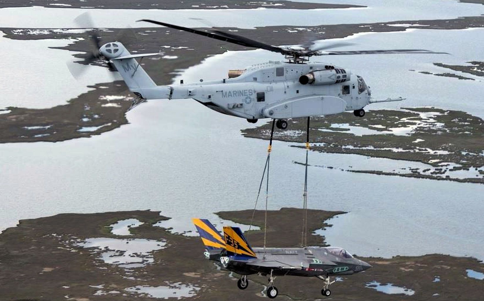 Now I have seen everything, a CH-53 carrying a slung F35 while ...