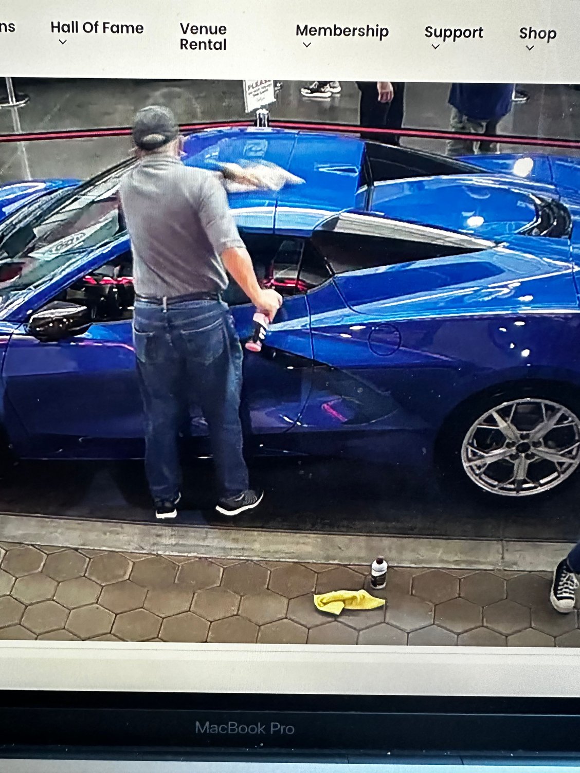 Buffing out car at NCM with Micro fiber rags on the ground ...